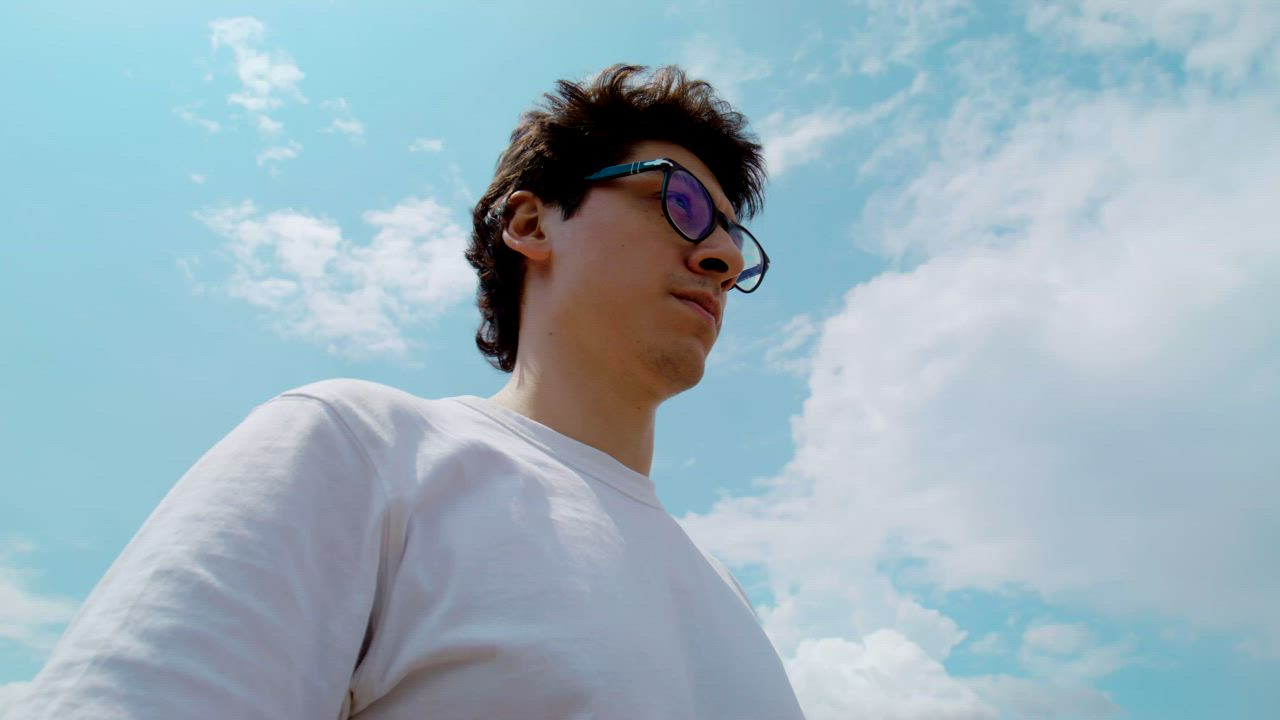 A young man testing his new professional camera outdoors - Free Stock Video