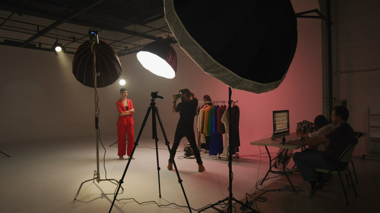 Model turns to pose as a photographer takes photos in a studio - Free ...