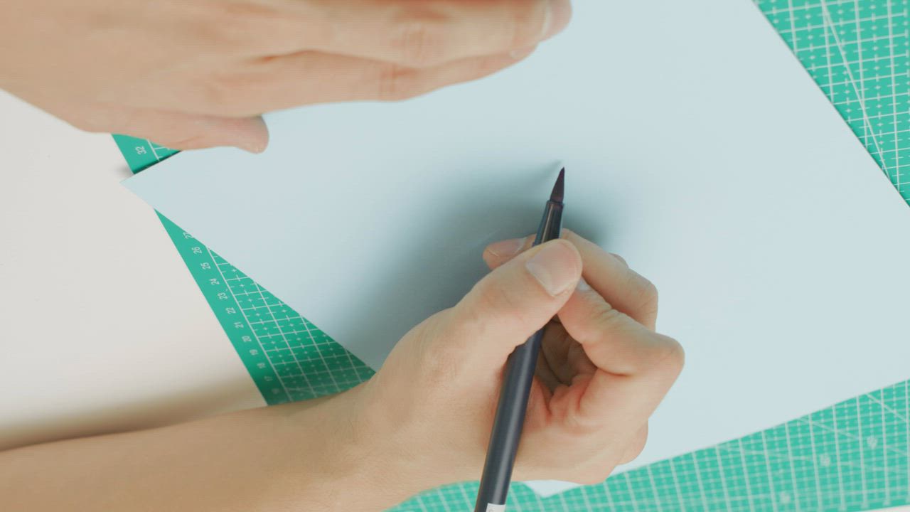 Calligraphy artist writing the word Happy in purple ink - Free Stock Video