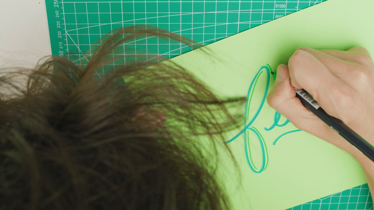 Aerial view of calligrapher writing Feels in cursive font - Free Stock ...