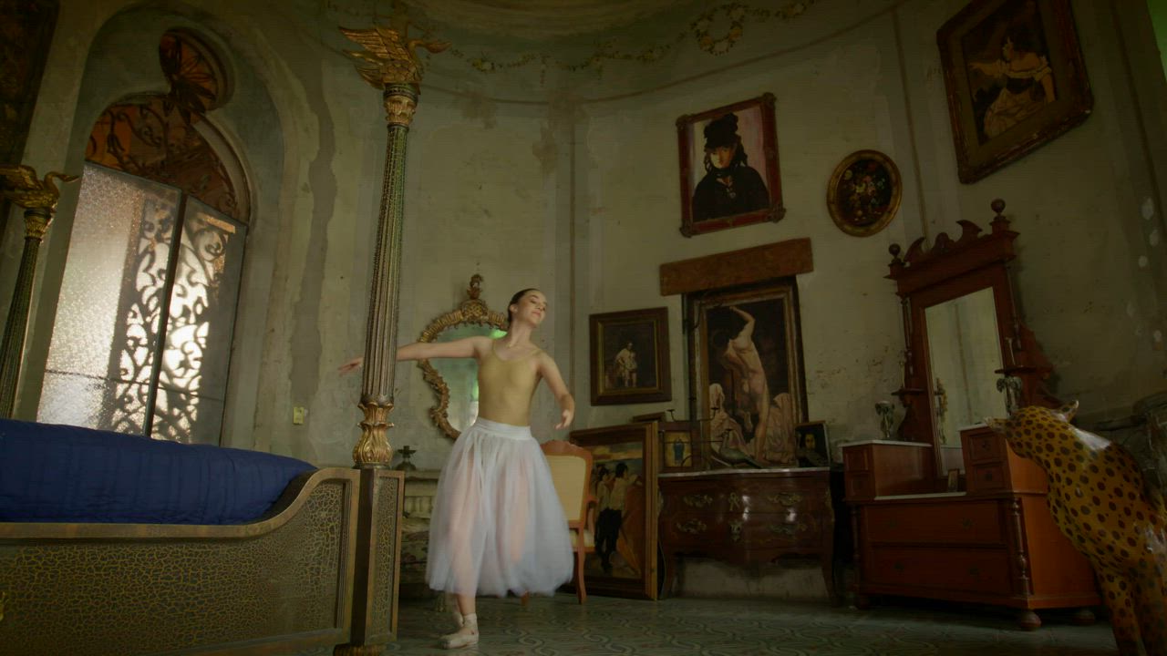 Ballerina performs classic ballet spins in a vintage decorated bedroom ...