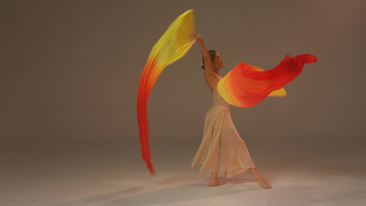 A young woman dancing with colorful ribbon fans - Free Stock Video