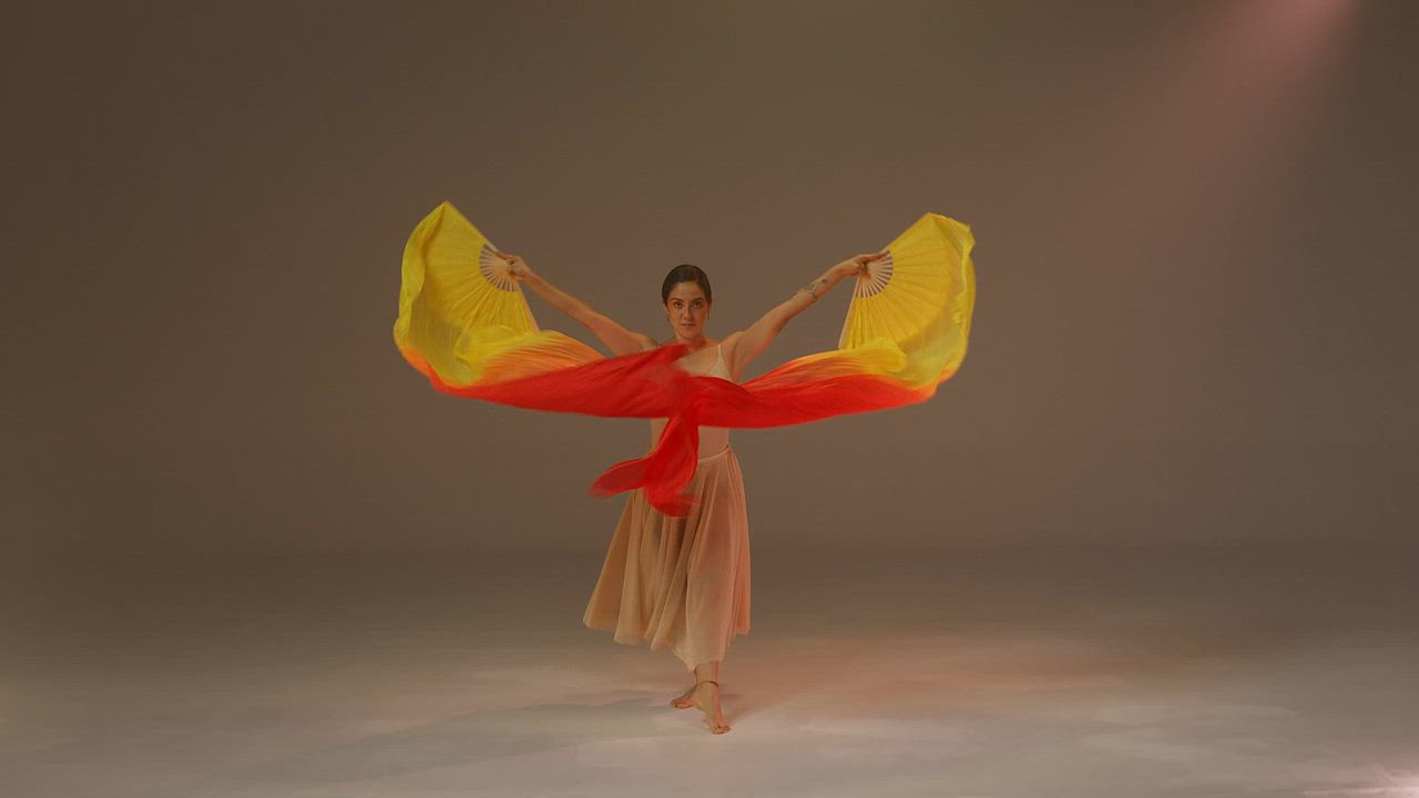 A young woman moves the ribbon fans with rhythm and grace - Free Stock ...