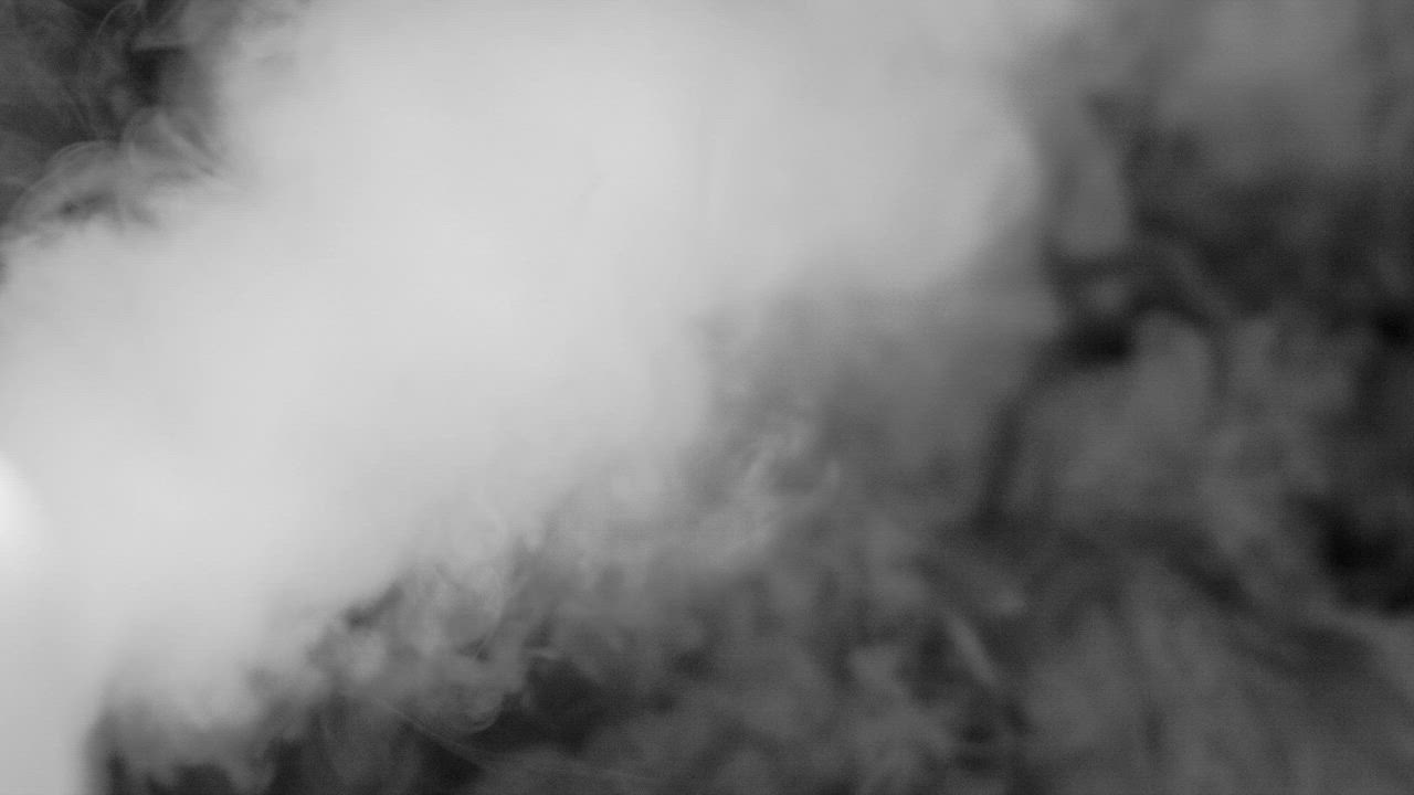 A light smoke rapidly scapes from the left side enveloping the dark ...