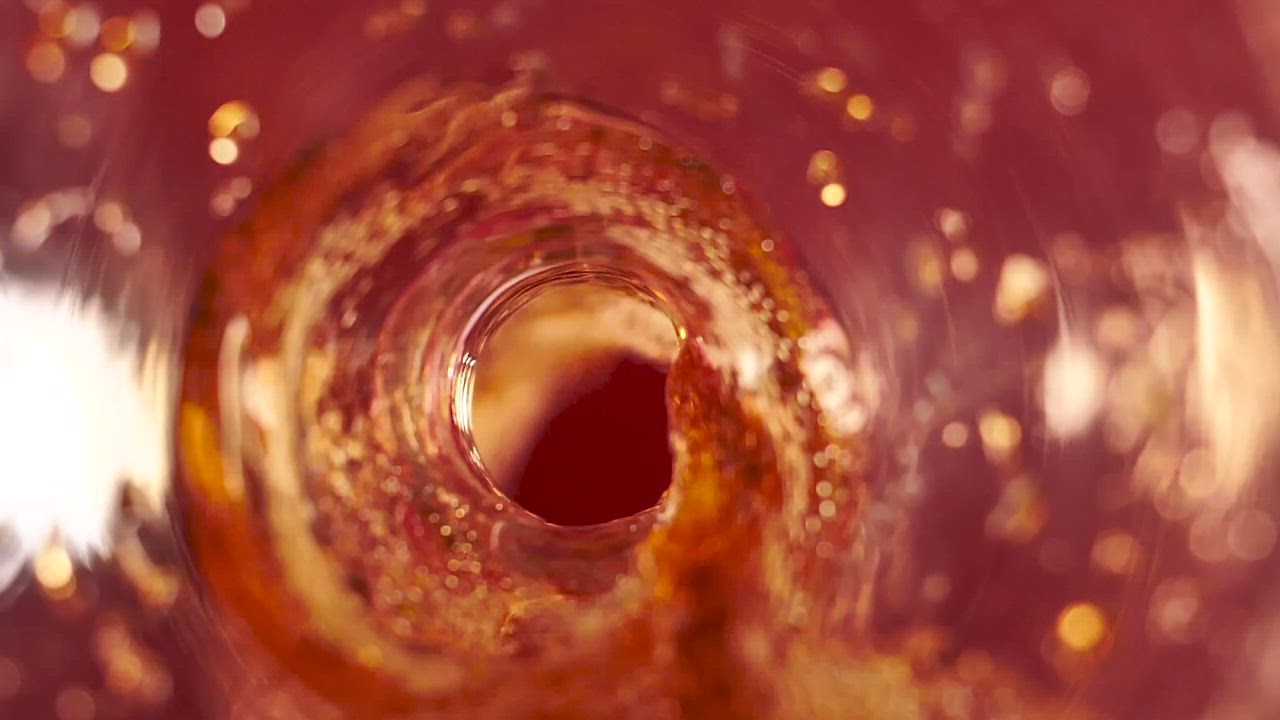 Soda coming out of a bottle seen from the inside - Free Stock Video