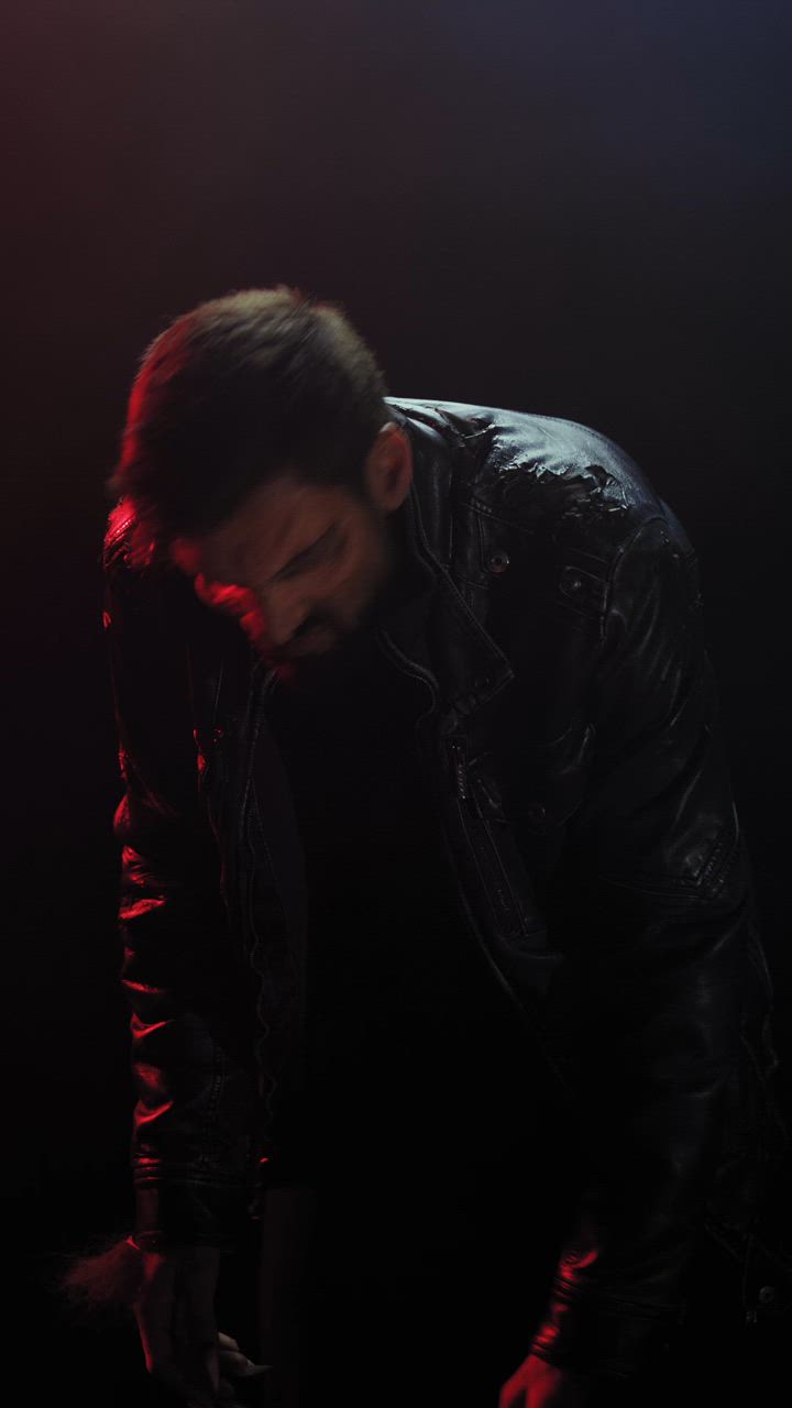 A werewolf wearing a leather jacket sniffs the air and looks to the ...