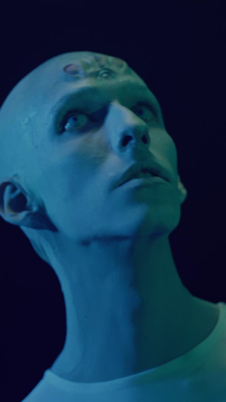 A bald pale skinned alien with strange protuberances on the forehead ...