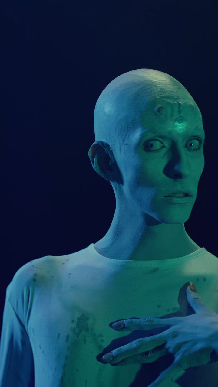 A bald pale skinned alien with strange protuberances on the forehead ...