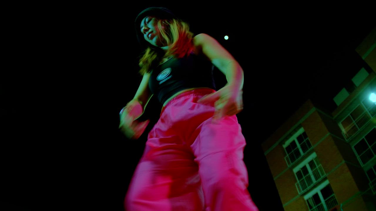 Lively dancing of a girl on the street at night - Free Stock Video