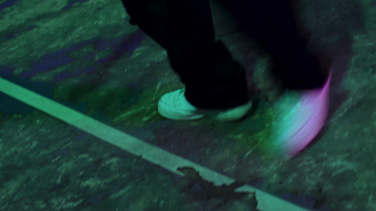 Feet and face of a man dancing at night on the street - Free Stock Video