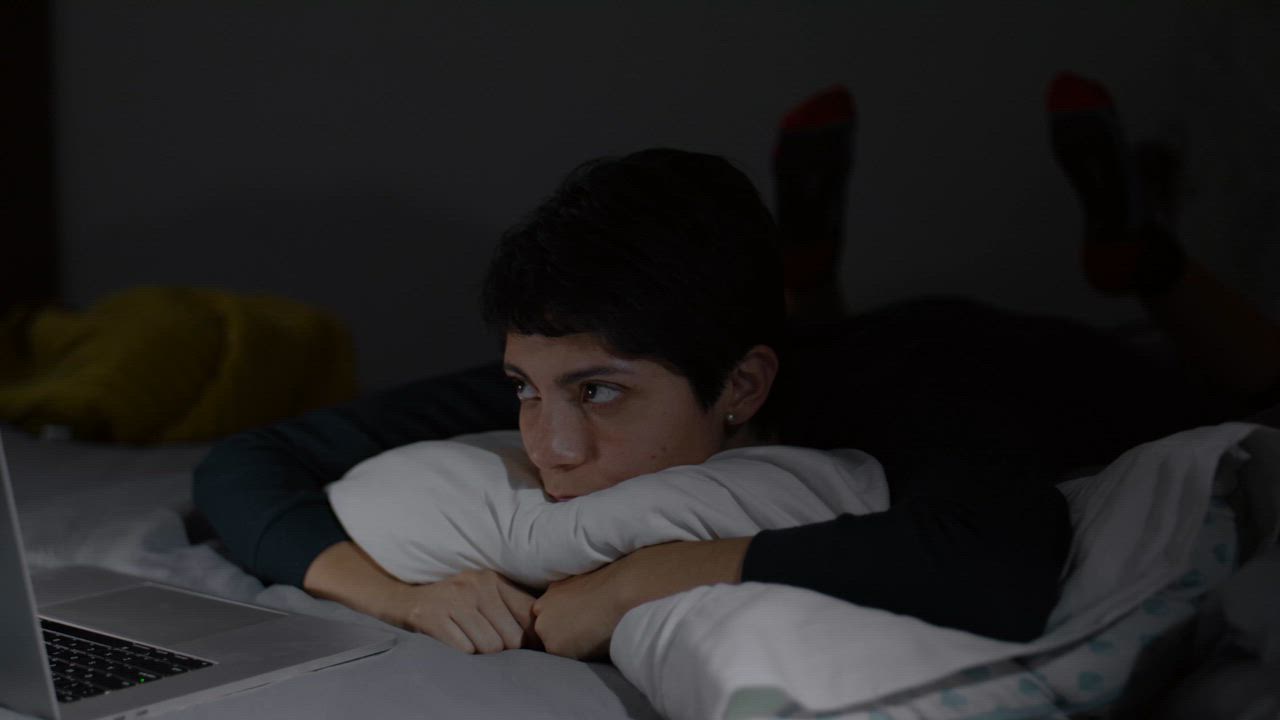 Young woman with insomnia on her laptop in her bed - Free Stock Video