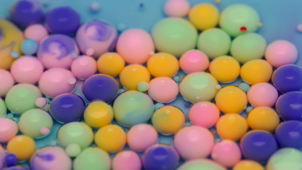 Close up of the texture of rotating colorful ink balls - Free Stock Video