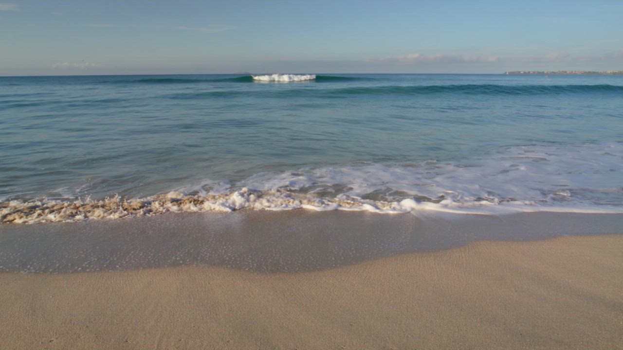 Layers of waves reaching the shore of the beach - Free Stock Video