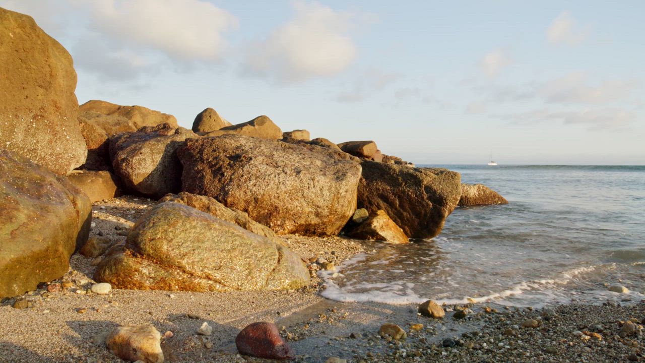 Yellow colored rocks on the coast on a sunny day - Free Stock Video