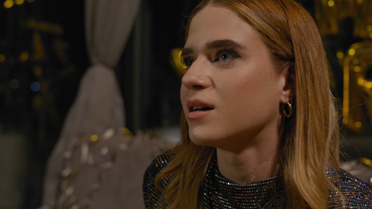 A young woman immersed in the conversation suddenly makes a toast and ...