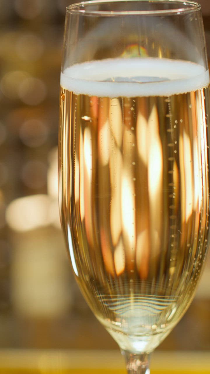 Crystal glasses filled with an effervescent golden champagne drink ...