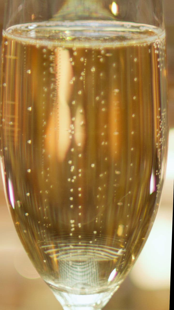 A mesmerizing golden bubbly drink close-up - Free Stock Video