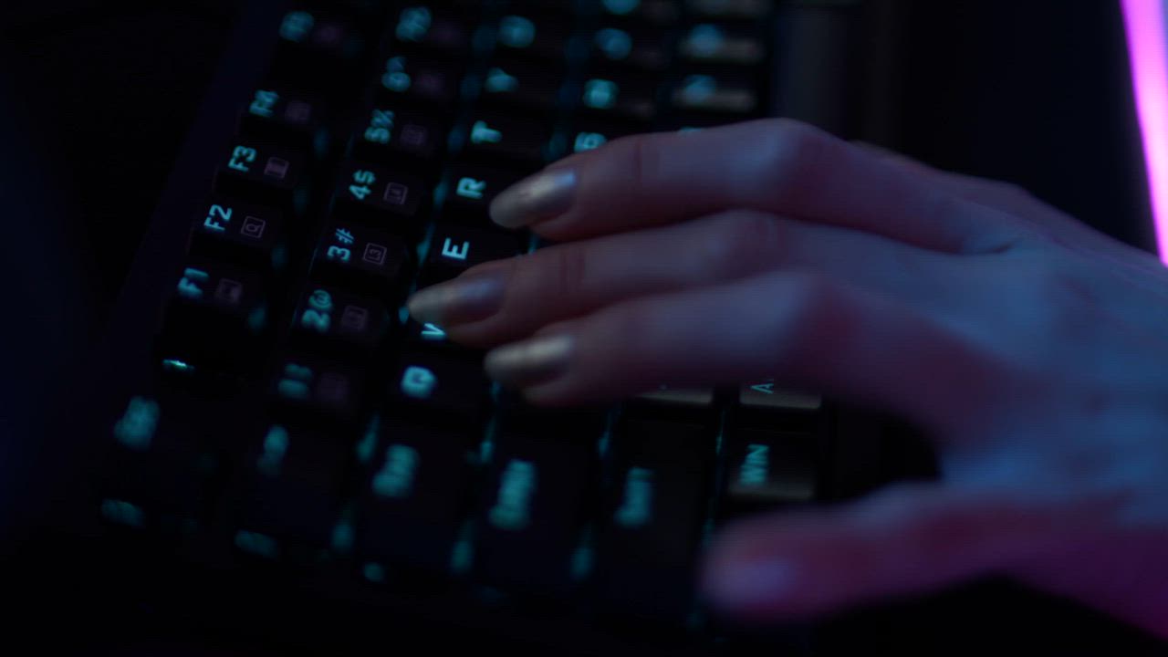 Hands typying in a retro backlit keyboard - Free Stock Video