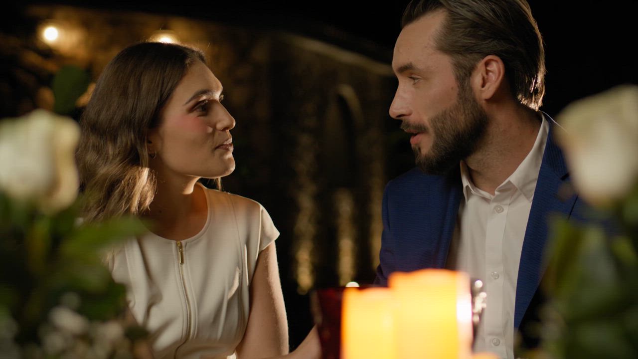 Couple in love having a conversation in a romantic environment adorned ...