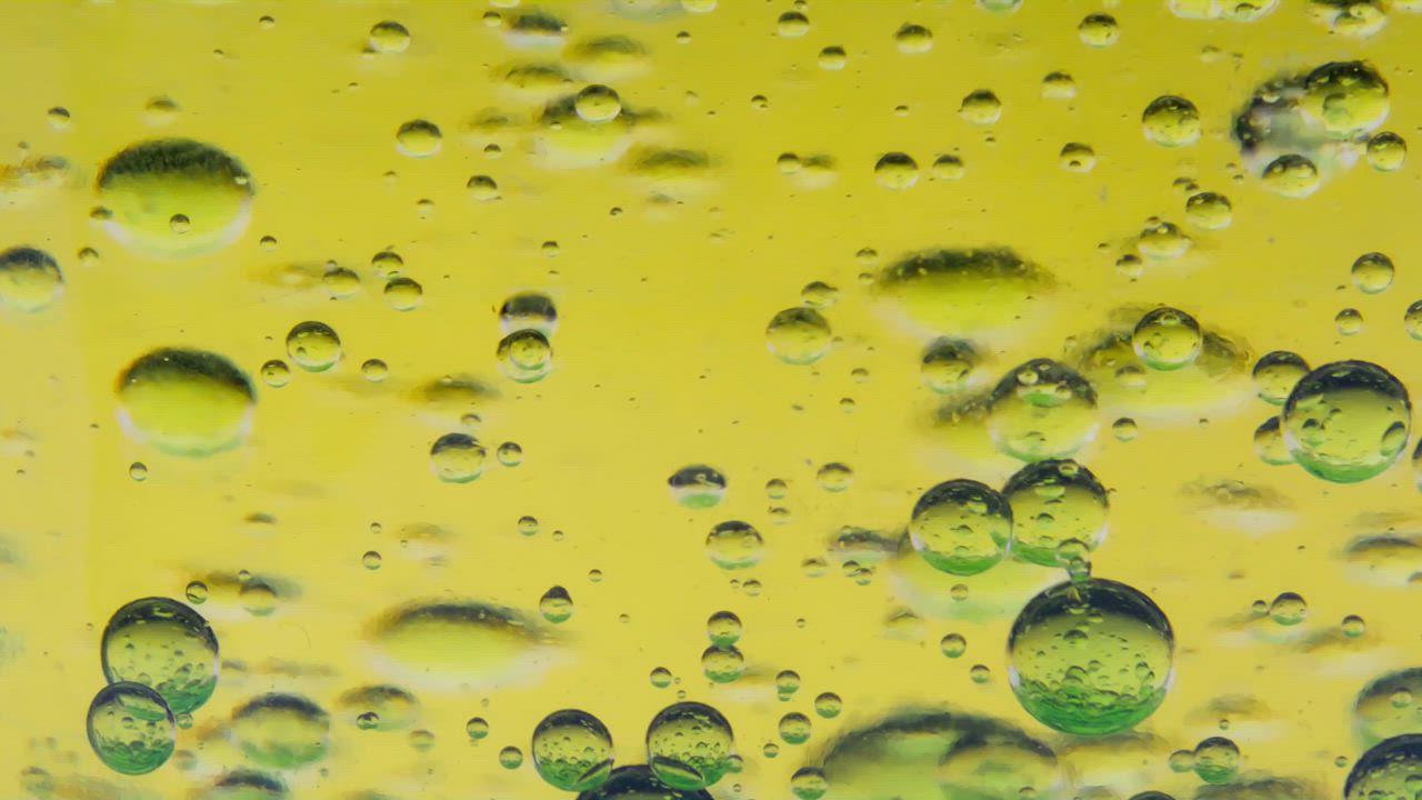 Thick liquid with bubbles seen very closely - Free Stock Video