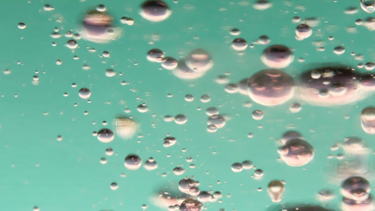 Abstract video of bubbles in a thick liquid - Free Stock Video