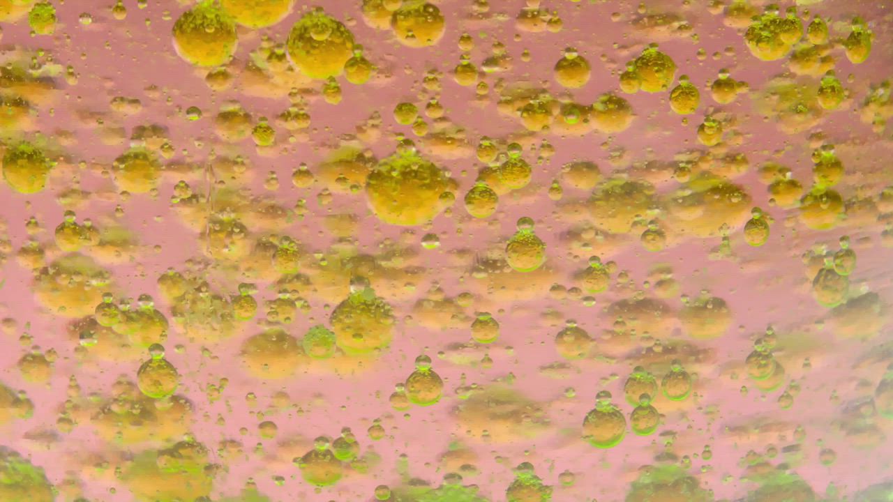 Strange texture of a bubbling yellow liquid - Free Stock Video