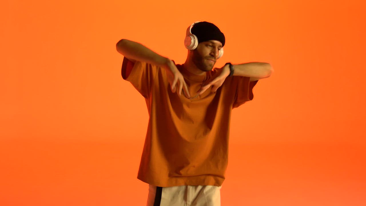 Portrait of a man dancing to the music in his headphones - Free Stock Video