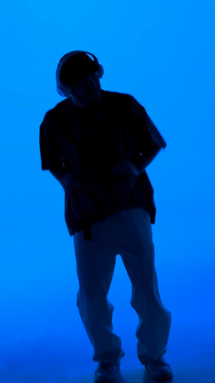 Intense dance of a man with headphones on a blue background - Free ...