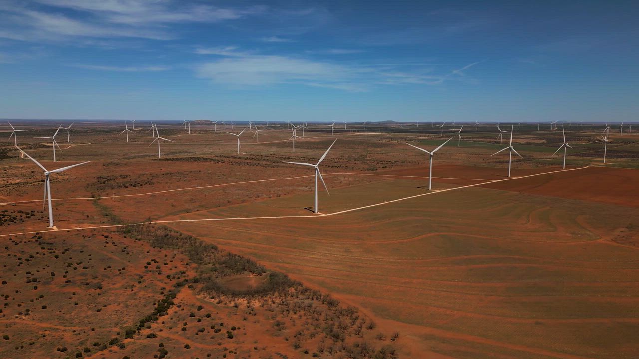 Aerial view of a field full of wind energy mills - Free Stock Video