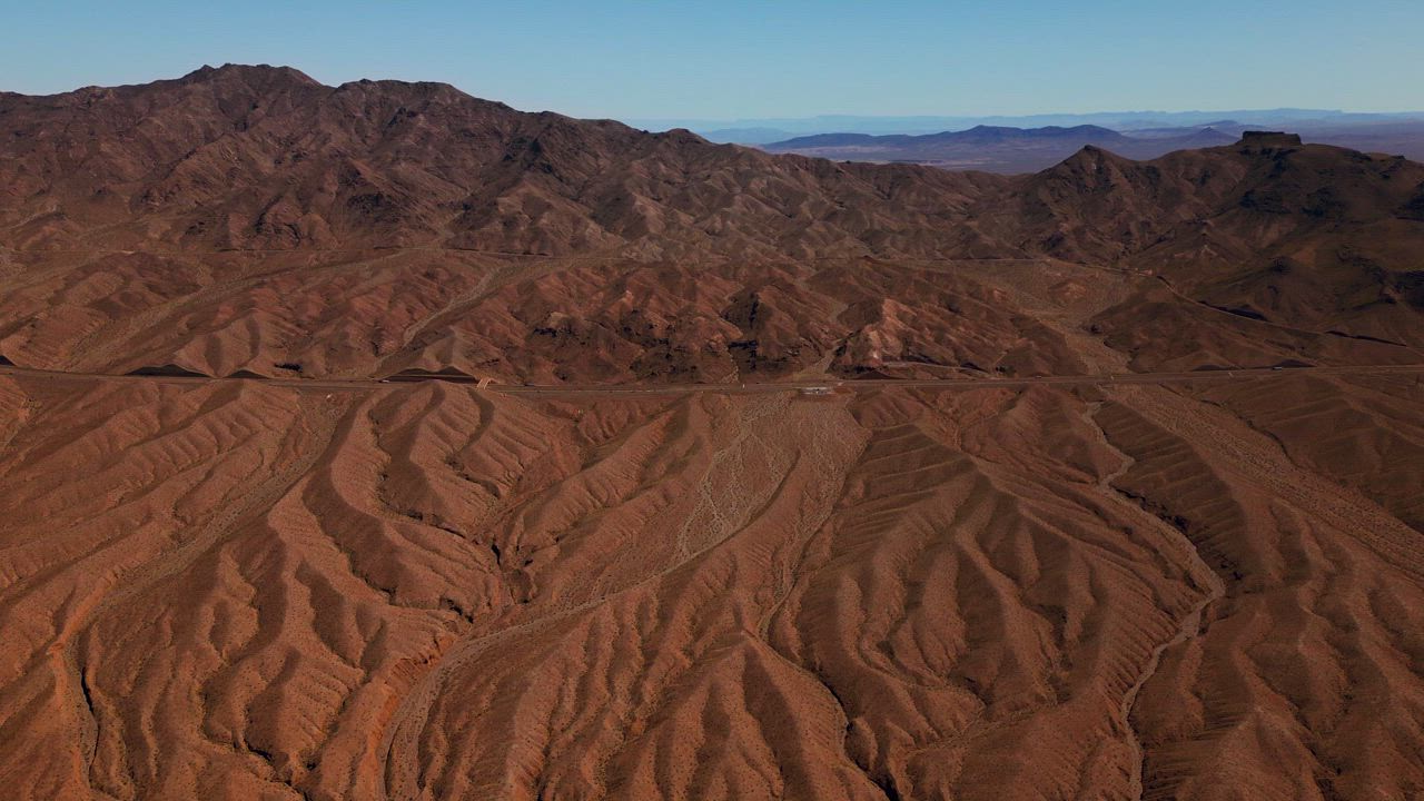Sandy mountain range with a road seen from above - Free Stock Video