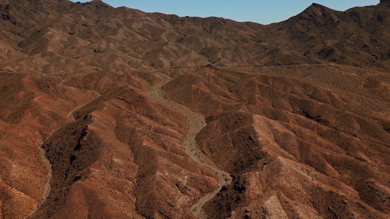 Sandy and rugged mountain range in an aerial view - Free Stock Video