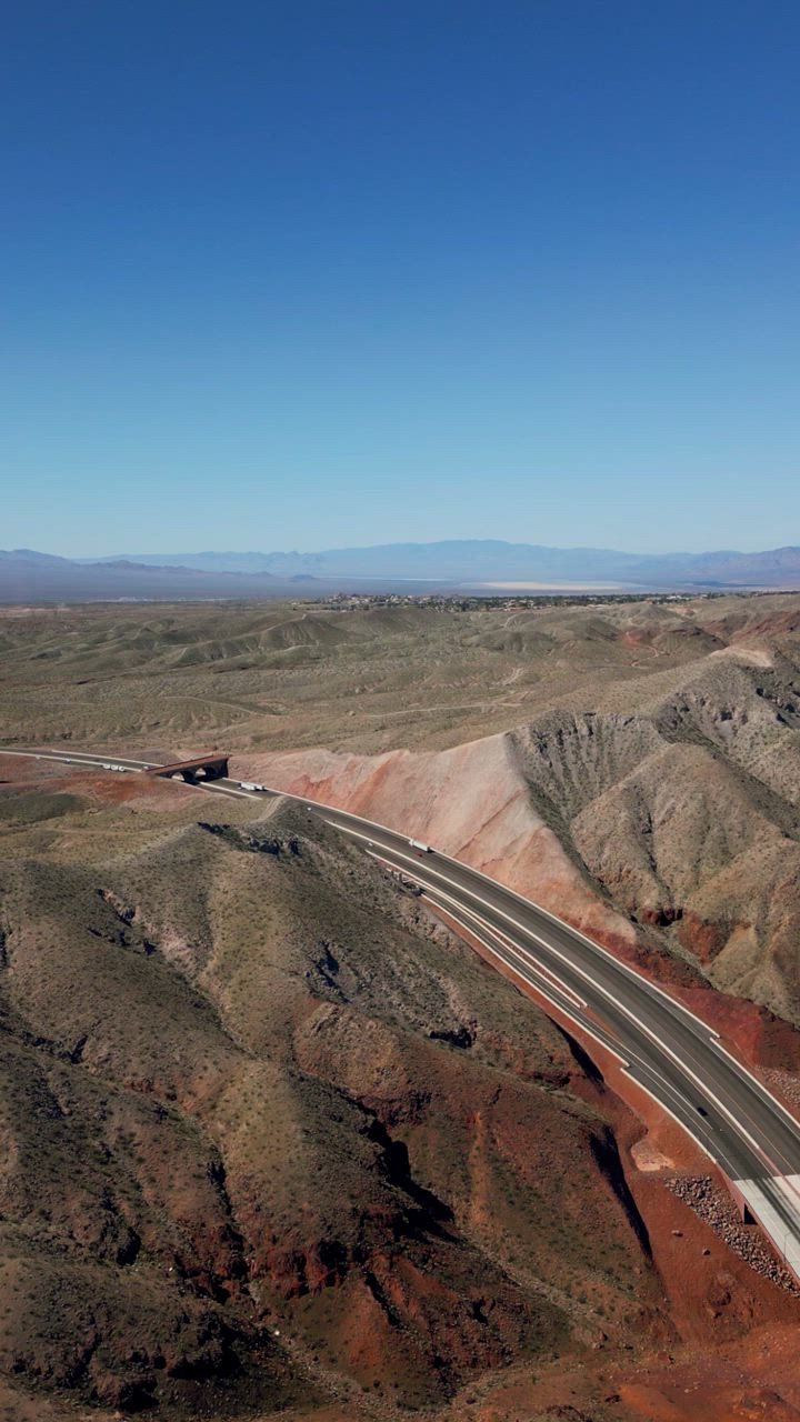 Road that passes through the rugged relief of a desert - Free Stock Video