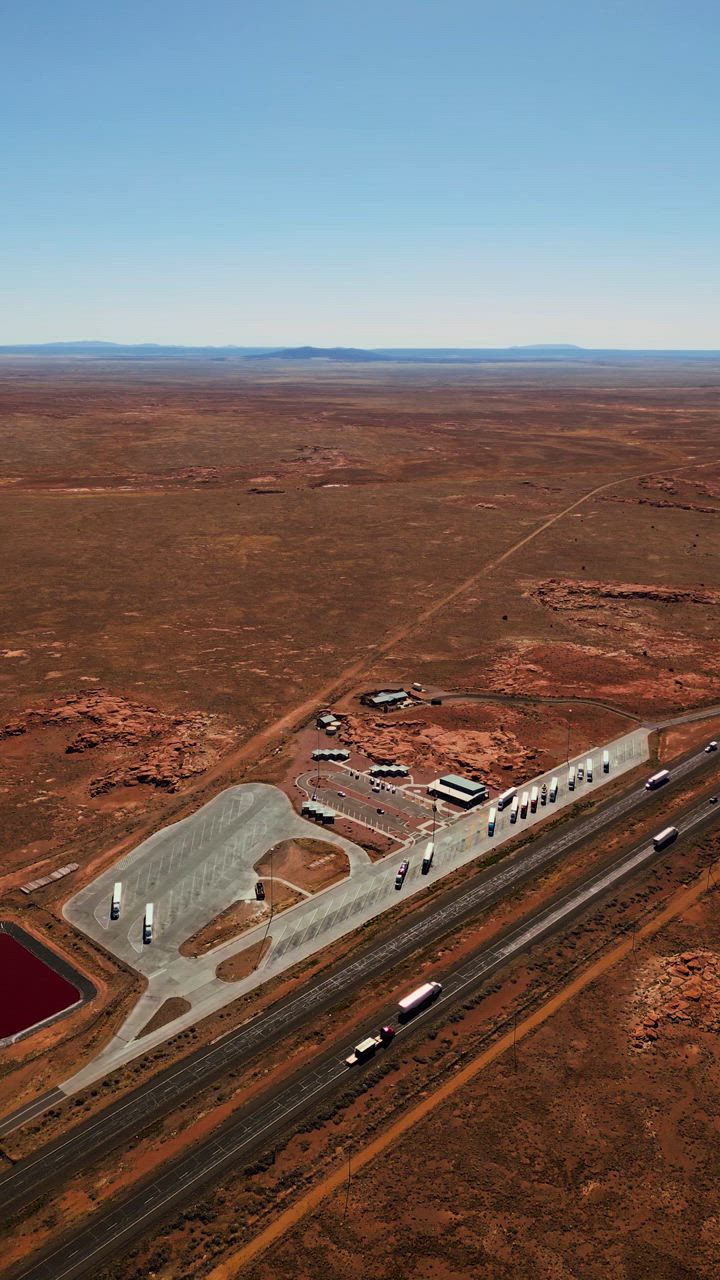 Highway and bus station in a sunny desert from above - Free Stock Video