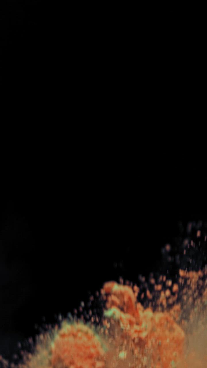 Orange and green powder detonating in slow motion - Free Stock Video