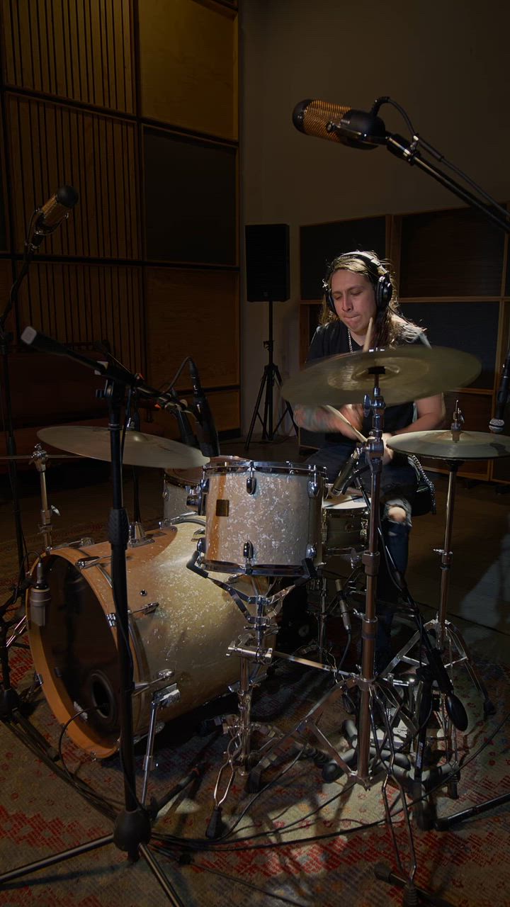 Drummer playing intensely in a recording studio - Free Stock Video