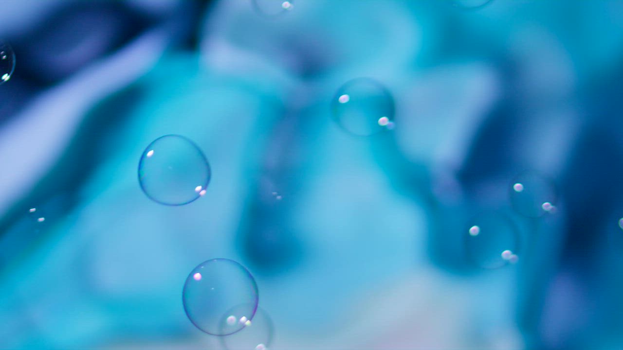 Abstract shot of moving bubbles on a blue background - Free Stock Video
