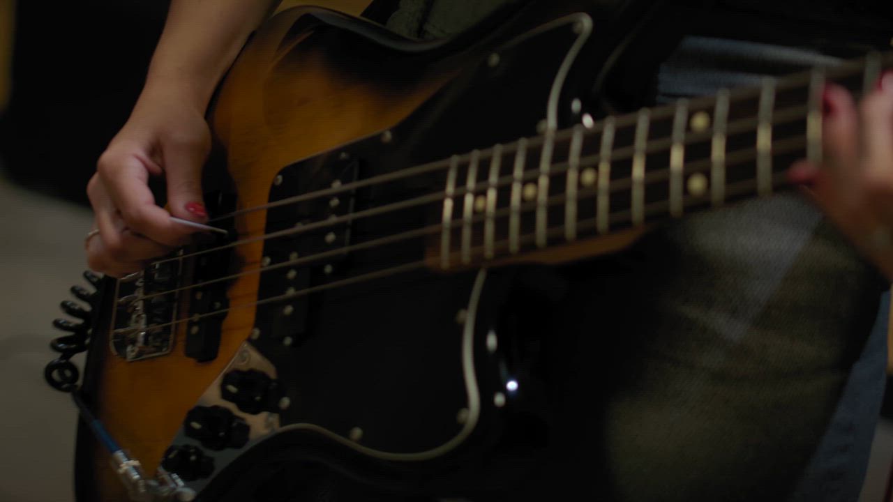Girl playing bass in a close shot of her hands - Free Stock Video