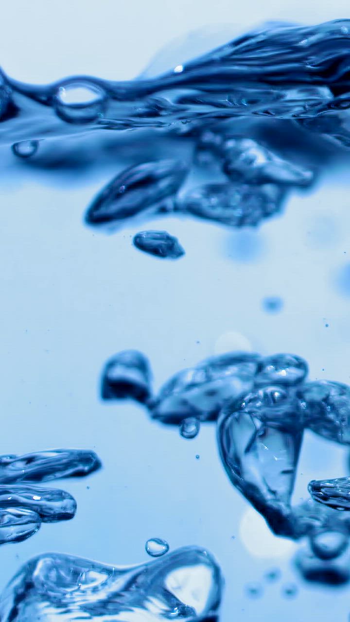 Many bubbles rising in water in slow motion - Free Stock Video