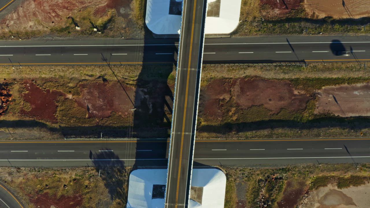 Aerial view of a highway crossing with transport vehicles moving on a ...