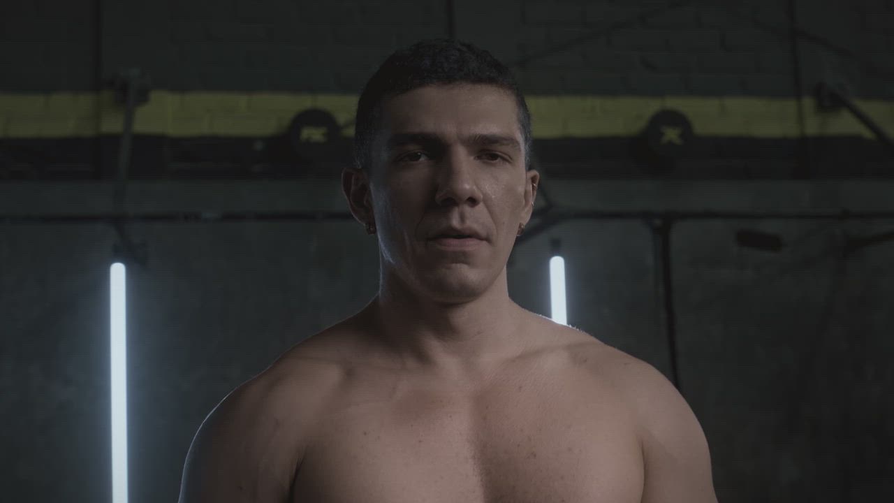 A shirtless strong muscular man deeply inhale and exhales on a pause on ...