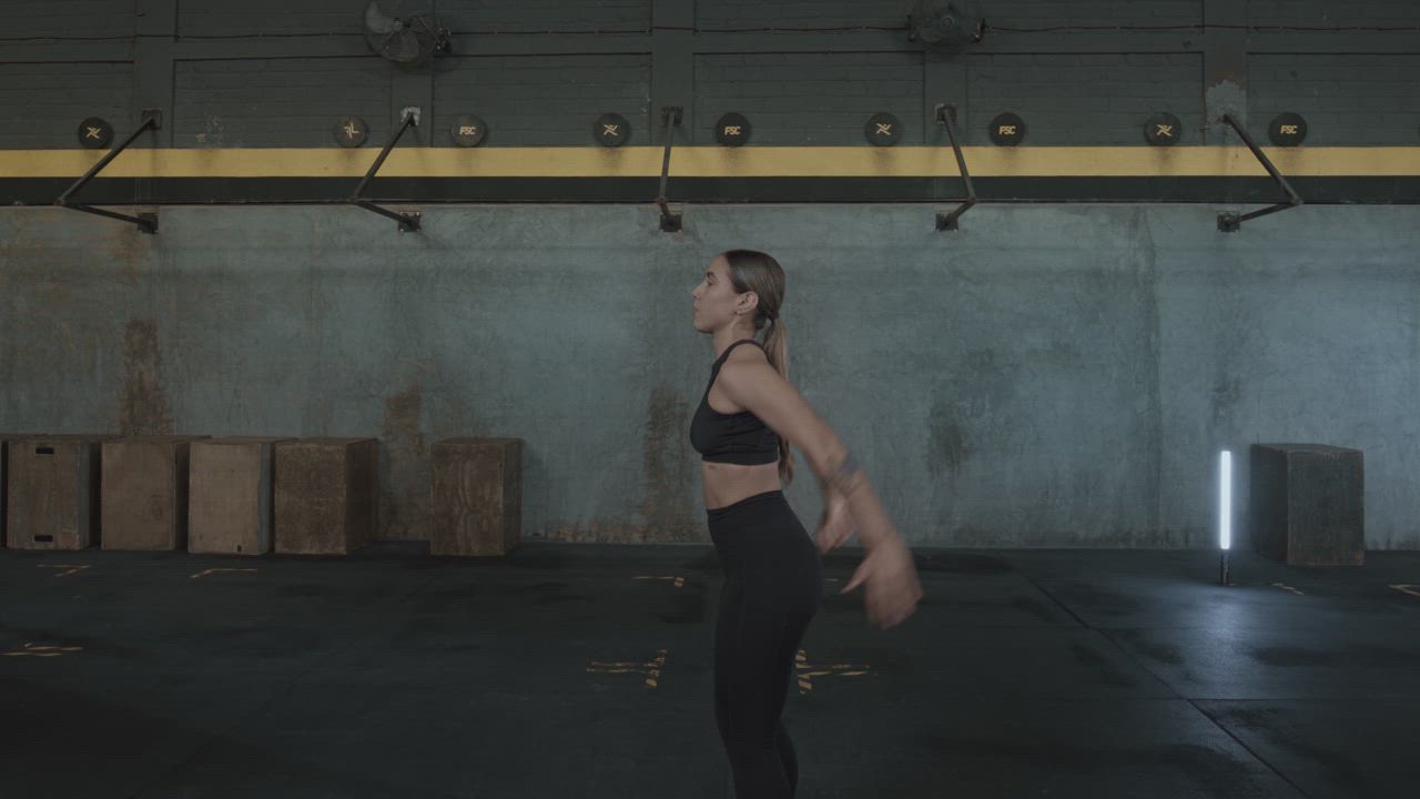 A young woman prepares for her workout session warming up her arms with ...