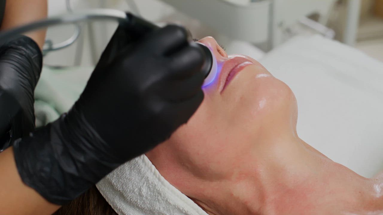 Woman undergoing facial laser treatment - Free Stock Video