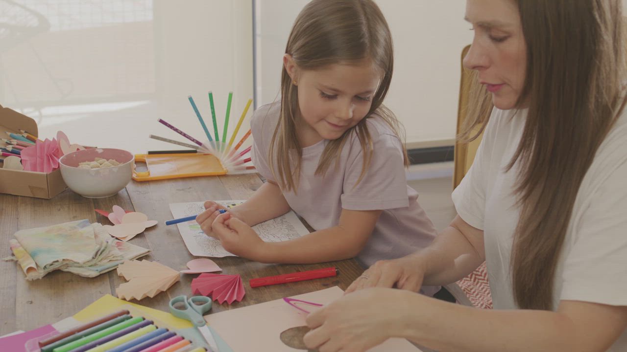 A young mother and her daughter bond over creating creative handicrafts ...