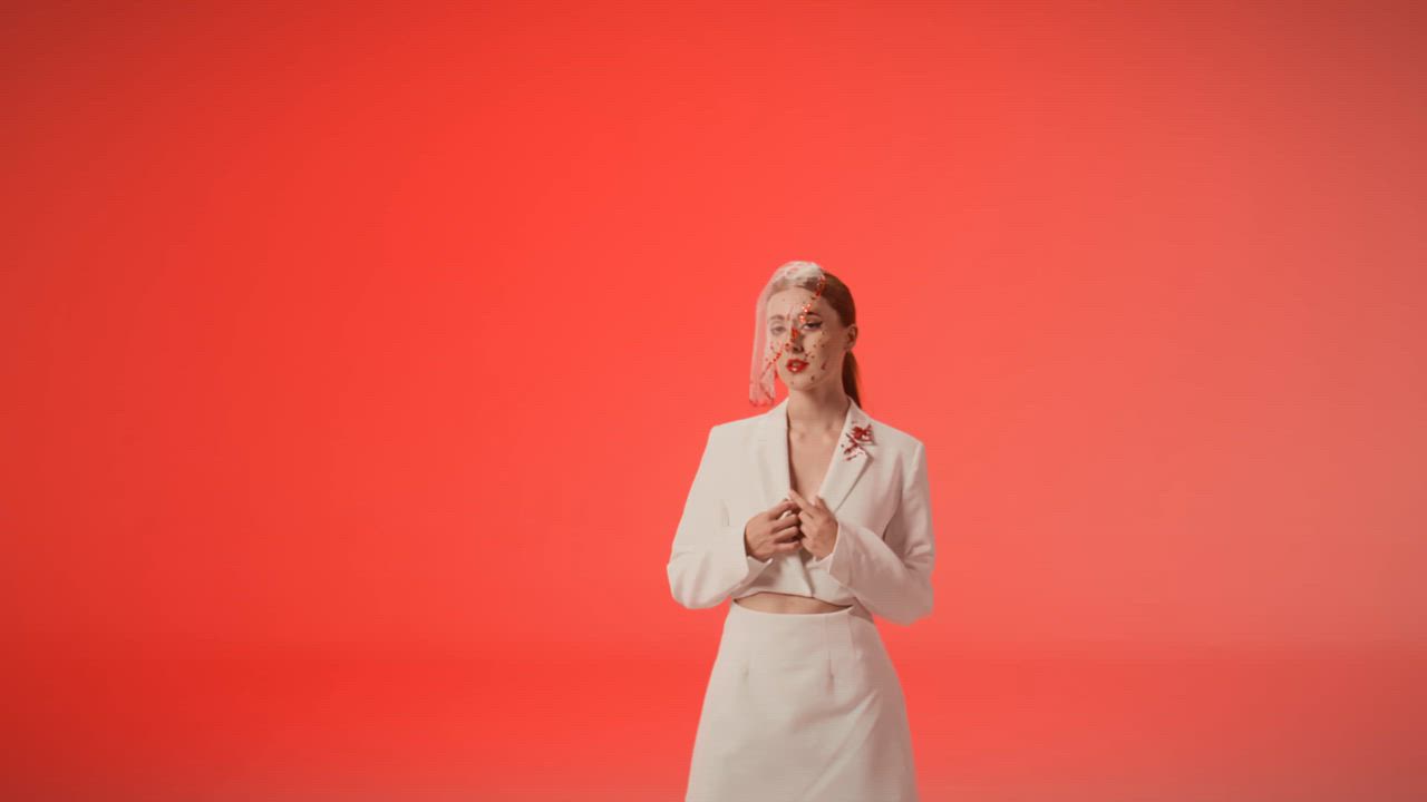 A young beautiful model posing over a red backdrop with a stunning ...