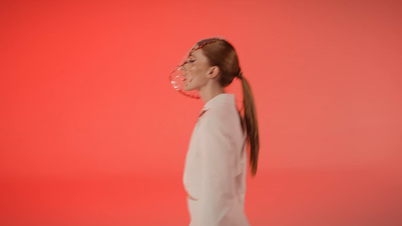 Cat walk of a young beautiful model wearing a white outfit over a ...