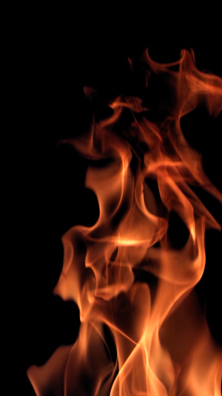 Close up shot of the vibrant flame tendrils elegantly flowing upwards ...