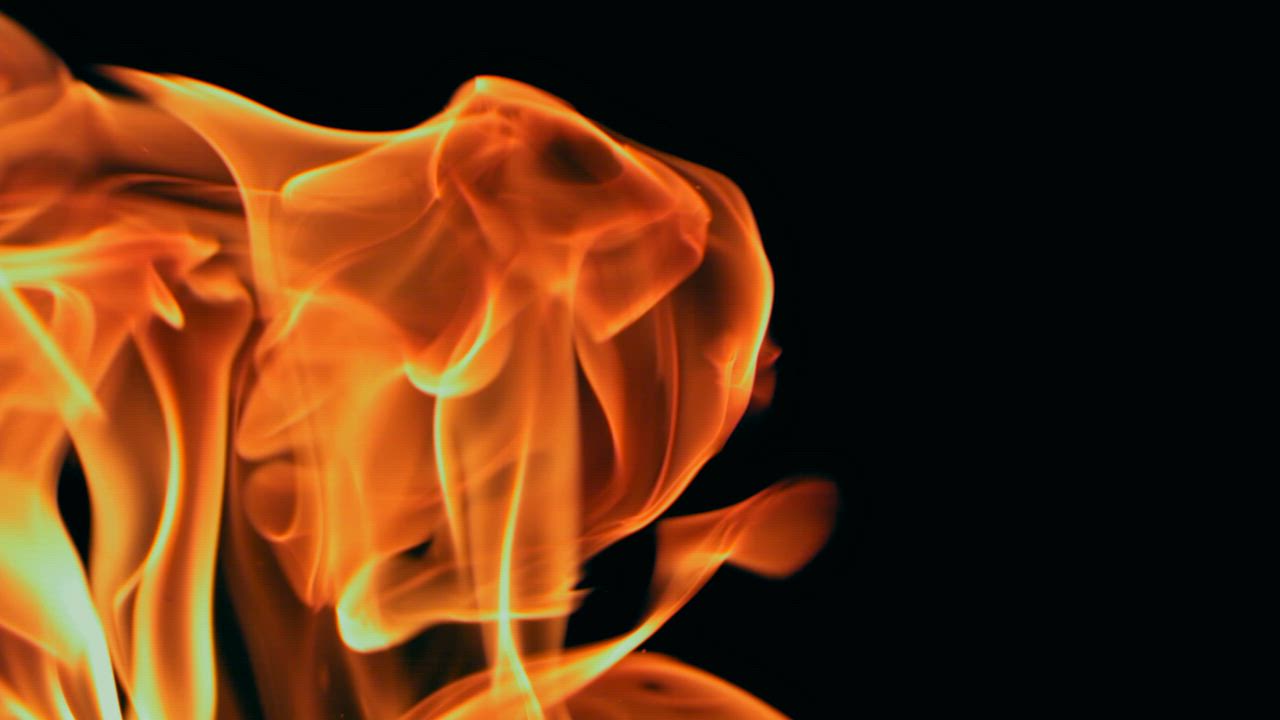 Flames gracefully flowing upwards over black background - Free Stock Video