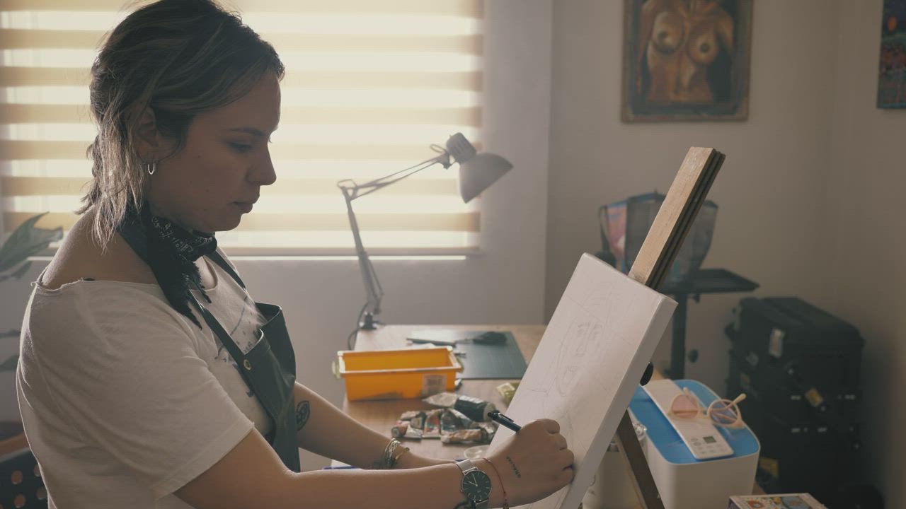 Woman drawing on a painting in her home studio - Free Stock Video