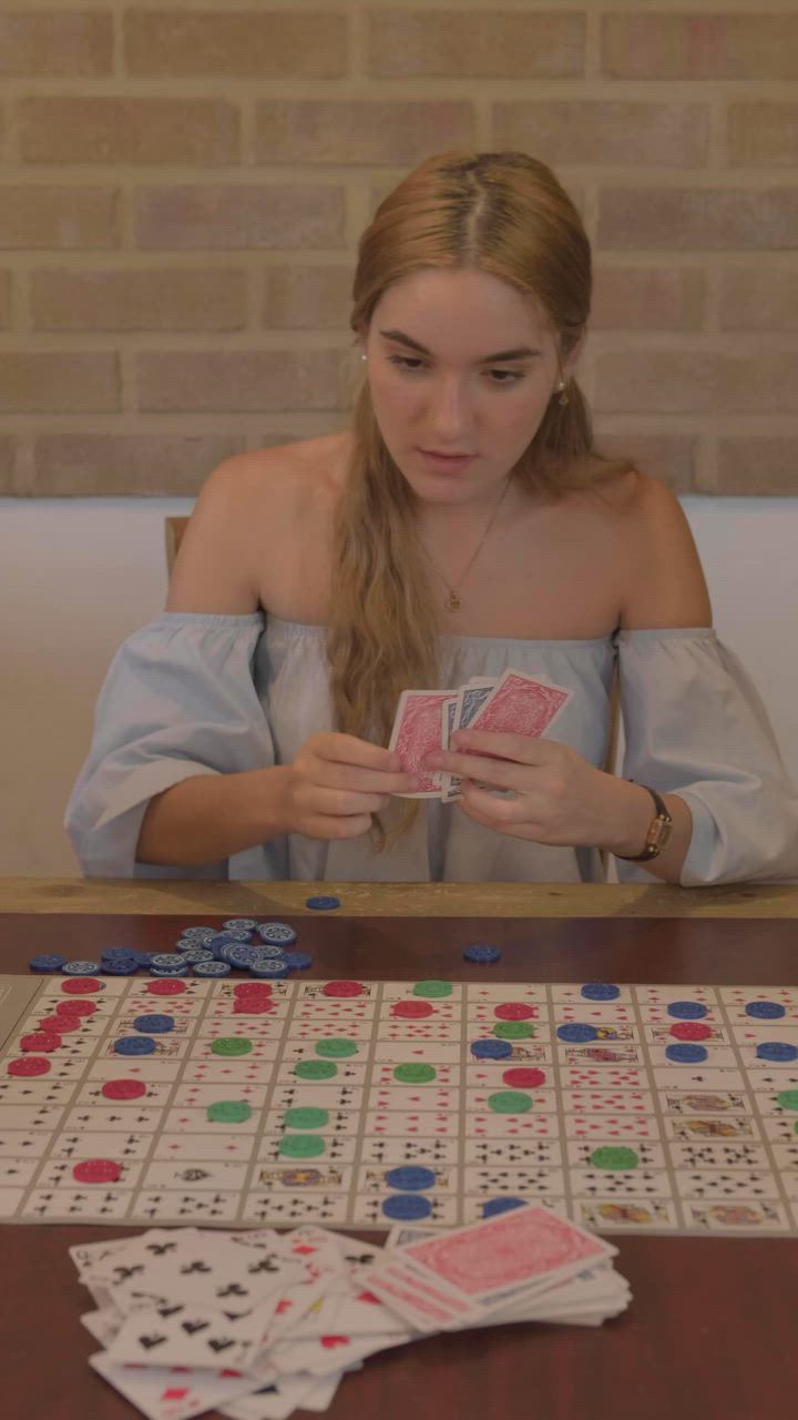 Young woman playing a board game with cards - Free Stock Video