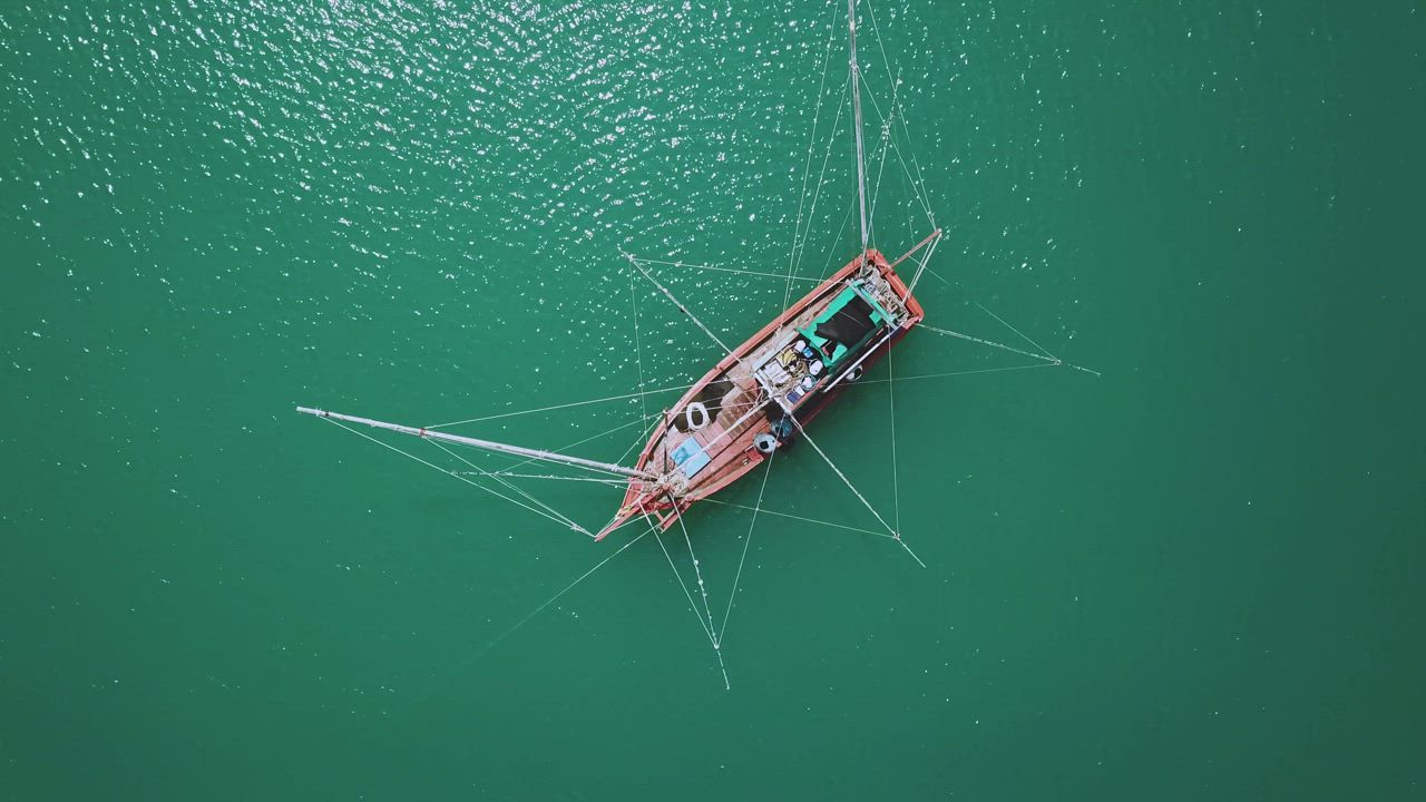 Boat in the middle of the sea seen from top - Free Stock Video